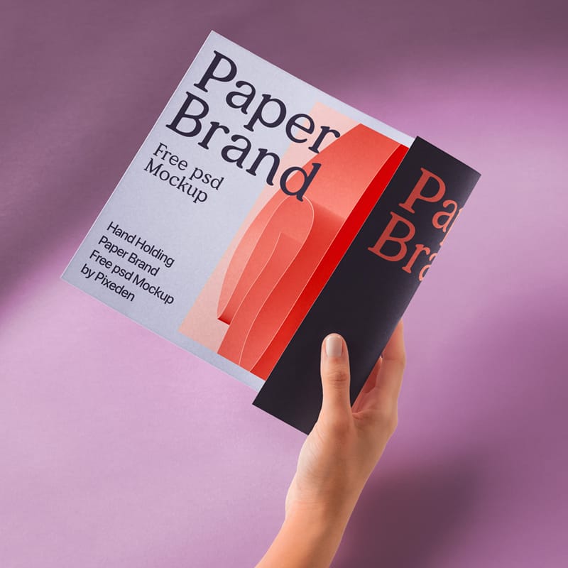 Free Hand Holding Paper Brand Mockup PSD
